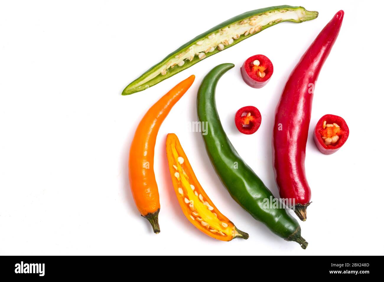 Colorful mix of chili pappers on white background Stock Photo - Alamy