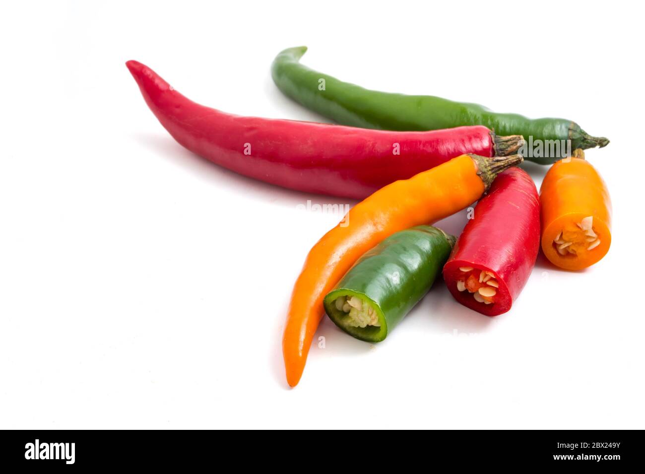Colorful mix of chili pappers on white background Stock Photo - Alamy