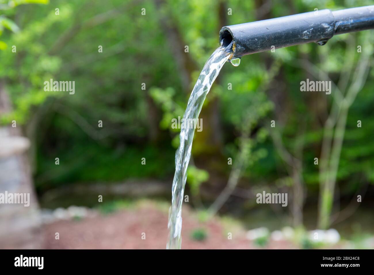 Pure spring water. Waterfall from the rock, cold and clear drinking ...