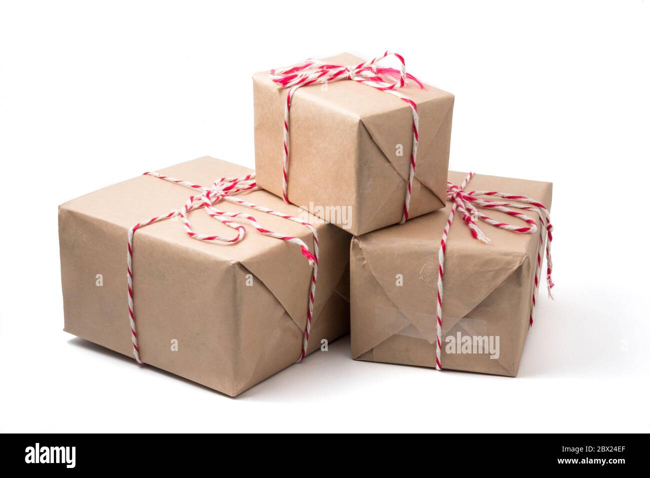 Gift packages wrapped in brown paper on white background Stock Photo ...
