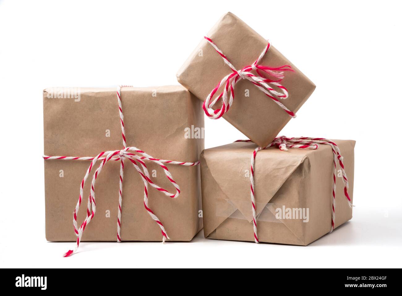 Gift packages wrapped in brown paper on white background Stock Photo ...