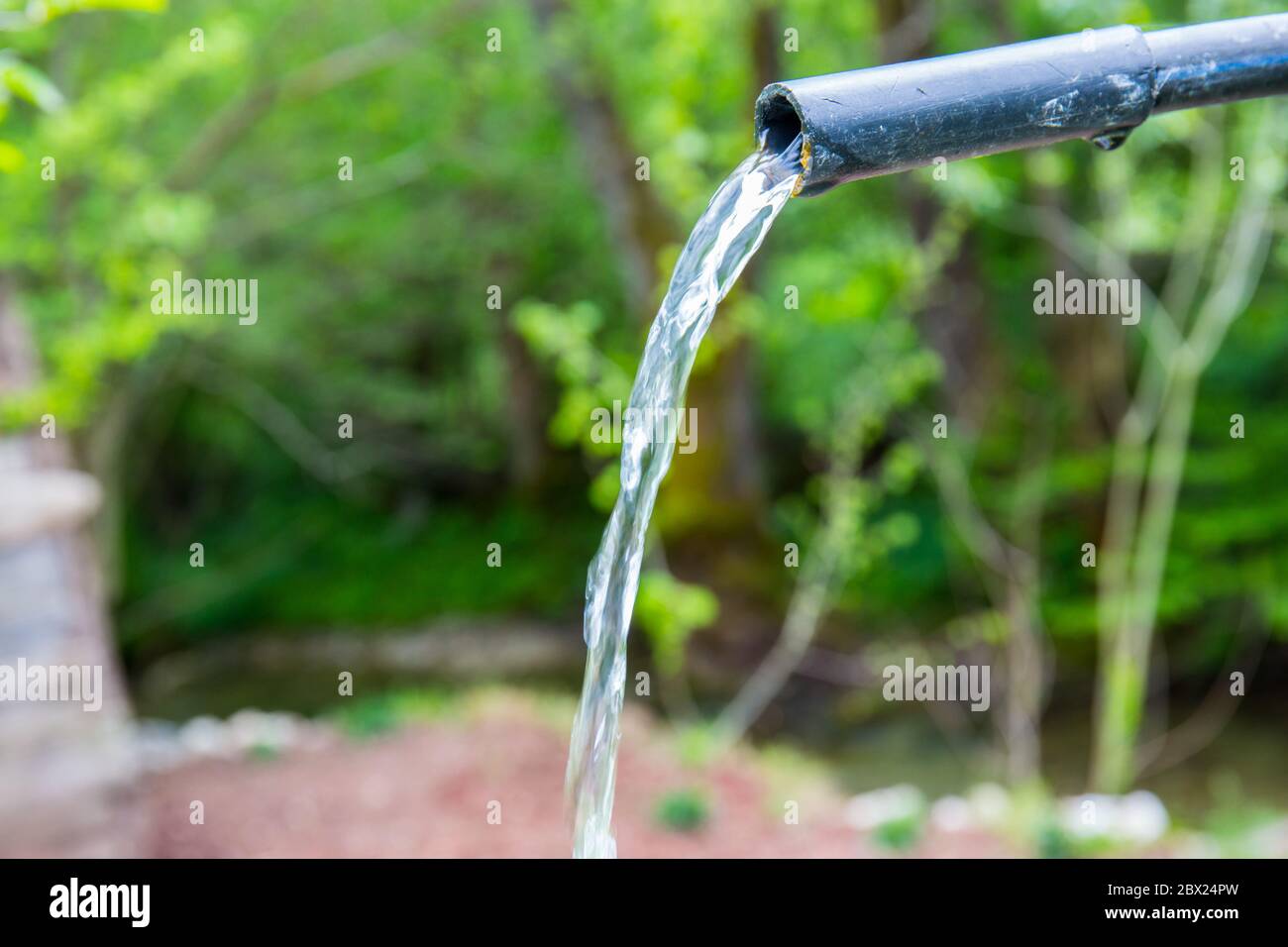 Pure spring water. Waterfall from the rock, cold and clear drinking ...
