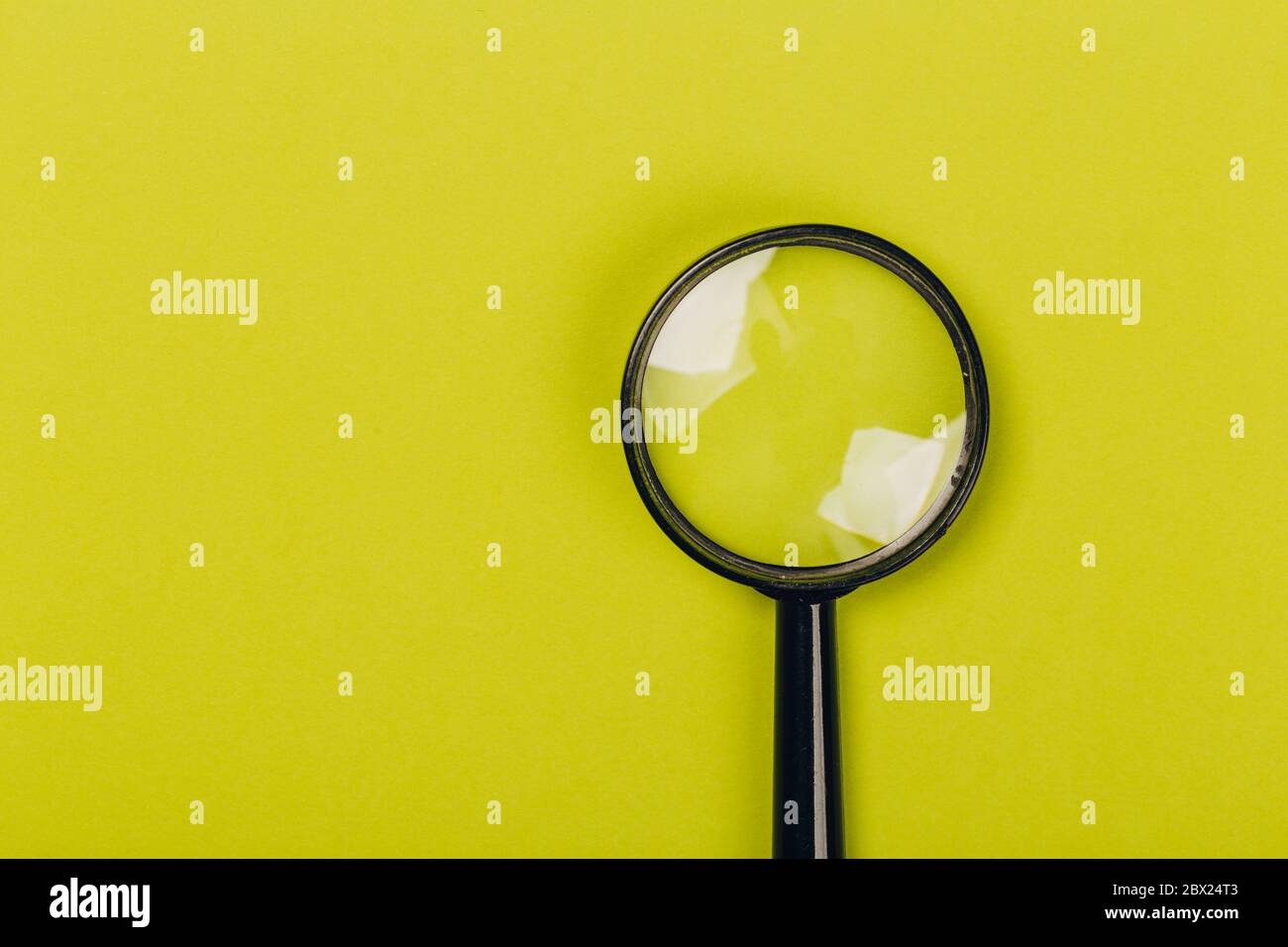 Small magnifying glass on green background, search symbol Stock Photo ...
