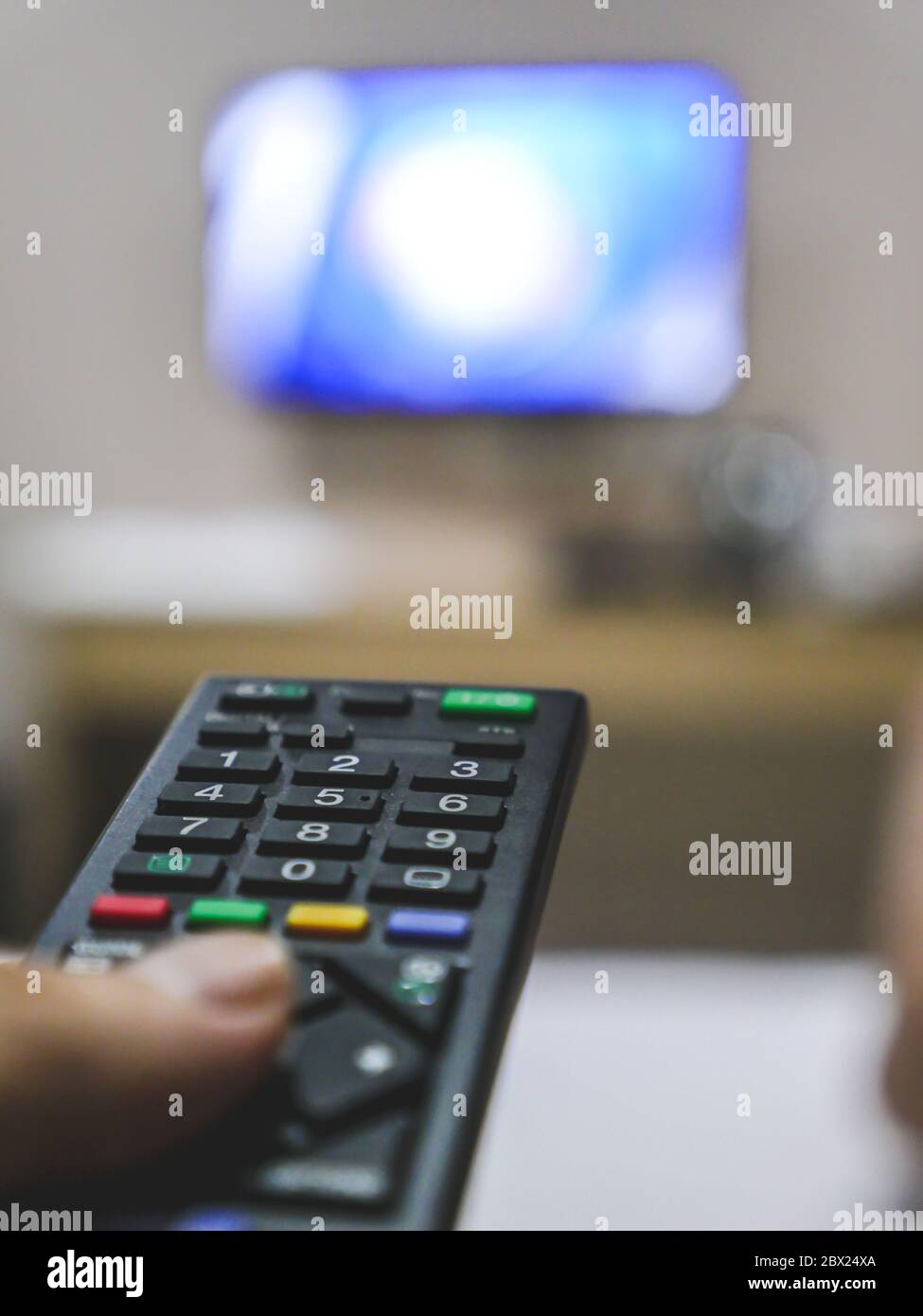 Television remote control in hand Stock Photo - Alamy