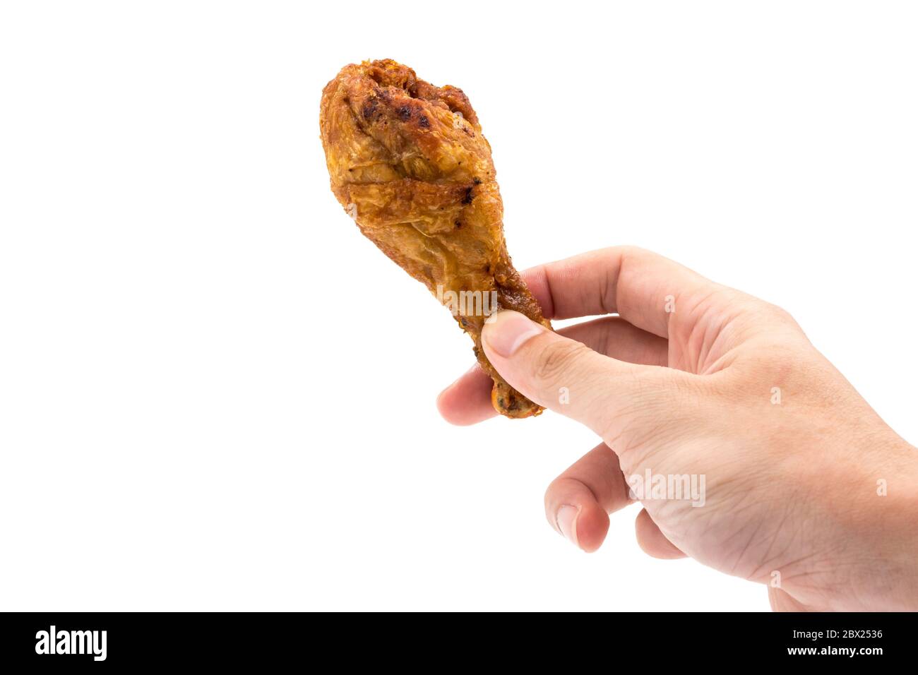 Hand holding Fried chicken leg on a white background Stock Photo - Alamy