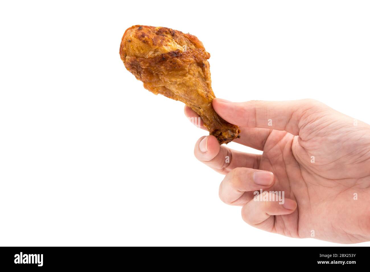 Hand holding grilled chicken wing Cut Out Stock Images & Pictures - Alamy