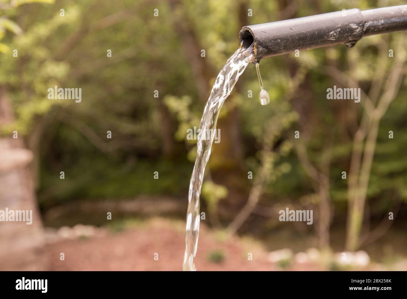 Pure spring water. Waterfall from the rock, cold and clear drinking ...