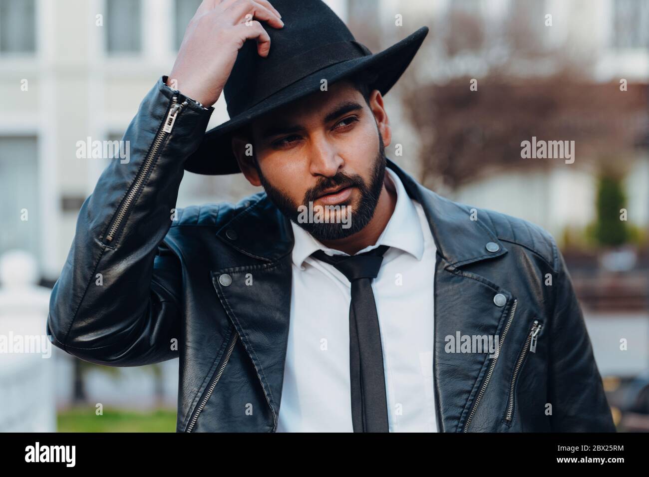 Handsome indian man in black hi-res stock photography and images - Alamy