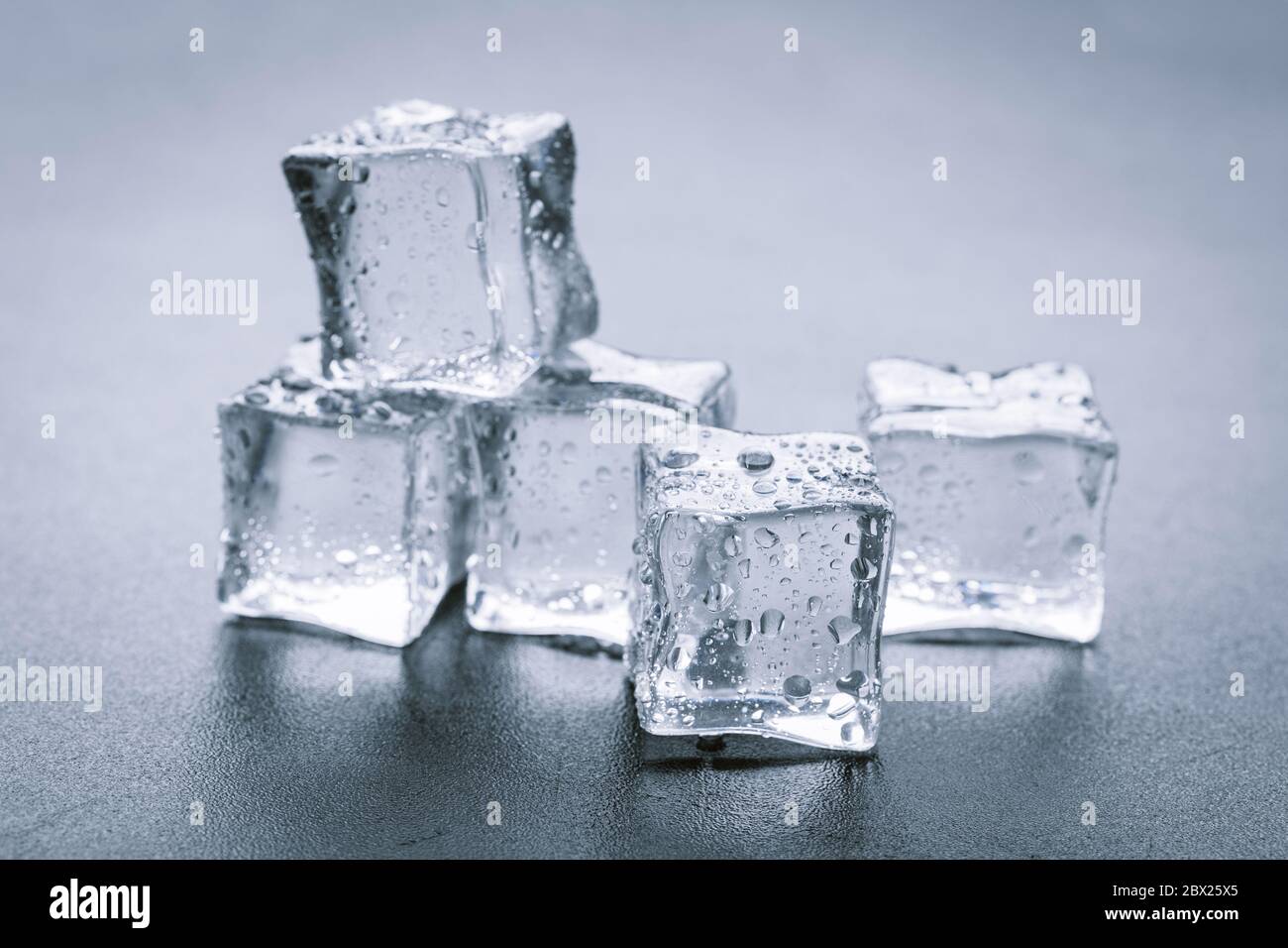 Ice cubes square with drops water clean on blue background Stock Photo ...