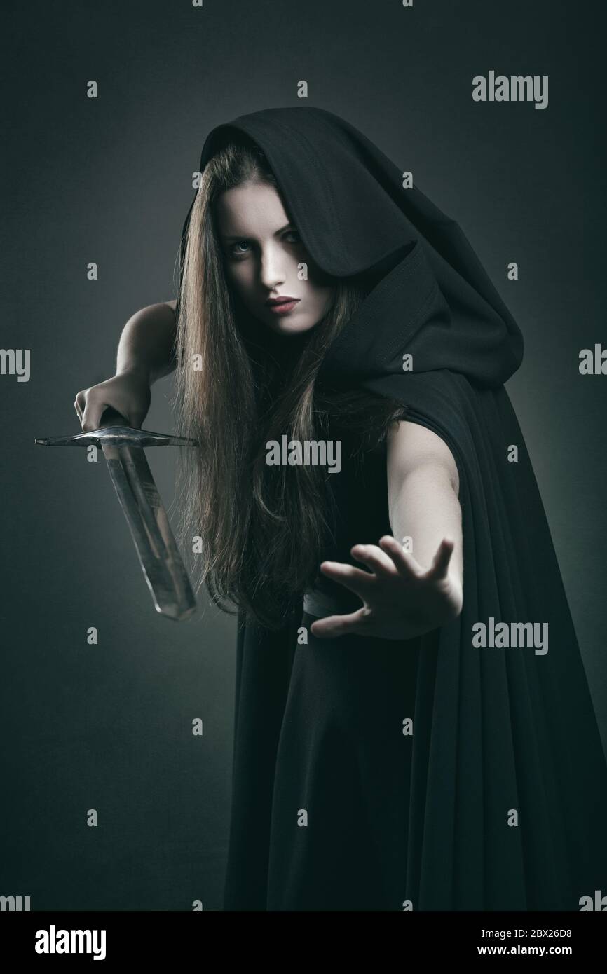 Beautiful dark woman with sword in fighting position . Fantasy and ...