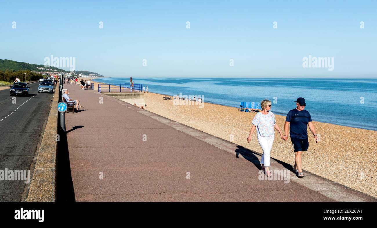 A Middle aged Couple walking along the Beach in The Hythe Kent Stock ...