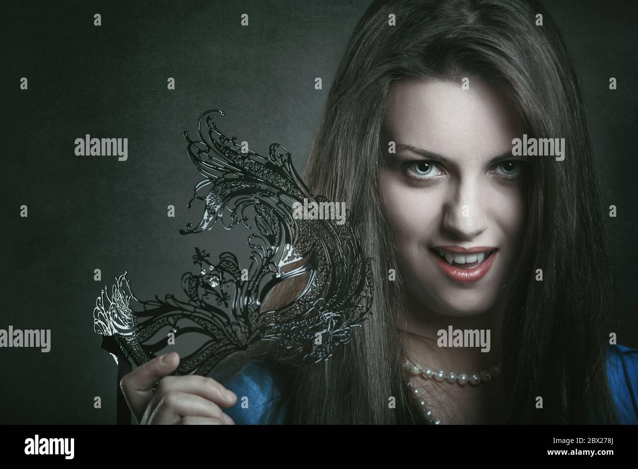 Beautiful vampire with venetian mask and evil expression . Halloween ...