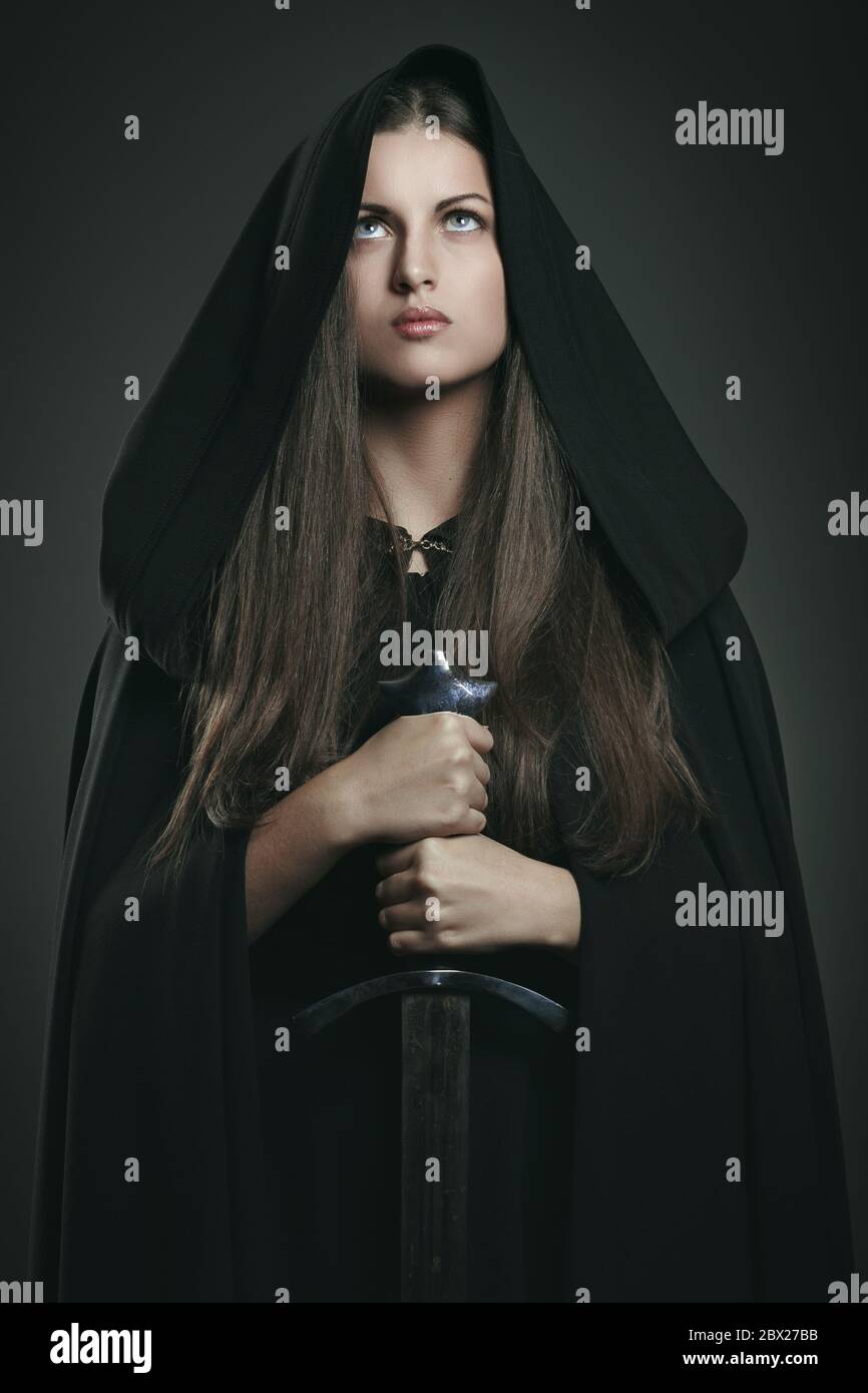 Beautiful woman with black cloak and sword . Fantasy and legend Stock ...