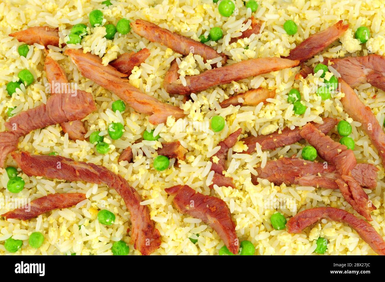 Egg fried rice with peas and pork strips background Stock Photo - Alamy