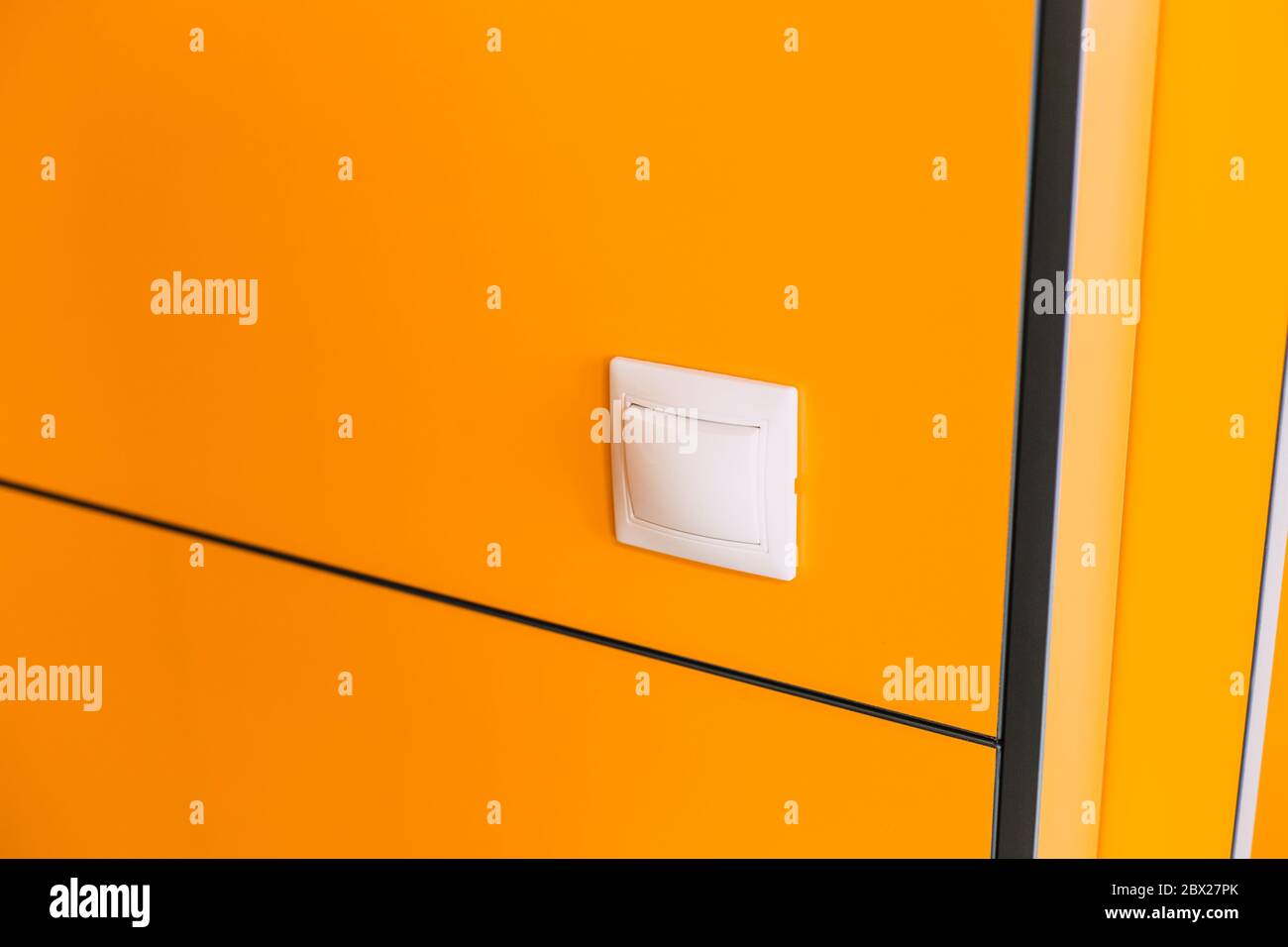 white light switch on a yellow wall Stock Photo - Alamy