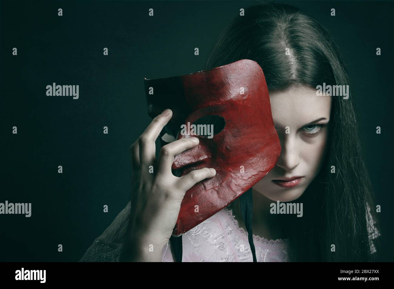 Evil gaze from beautiful pale woman with venetian mask Stock Photo - Alamy
