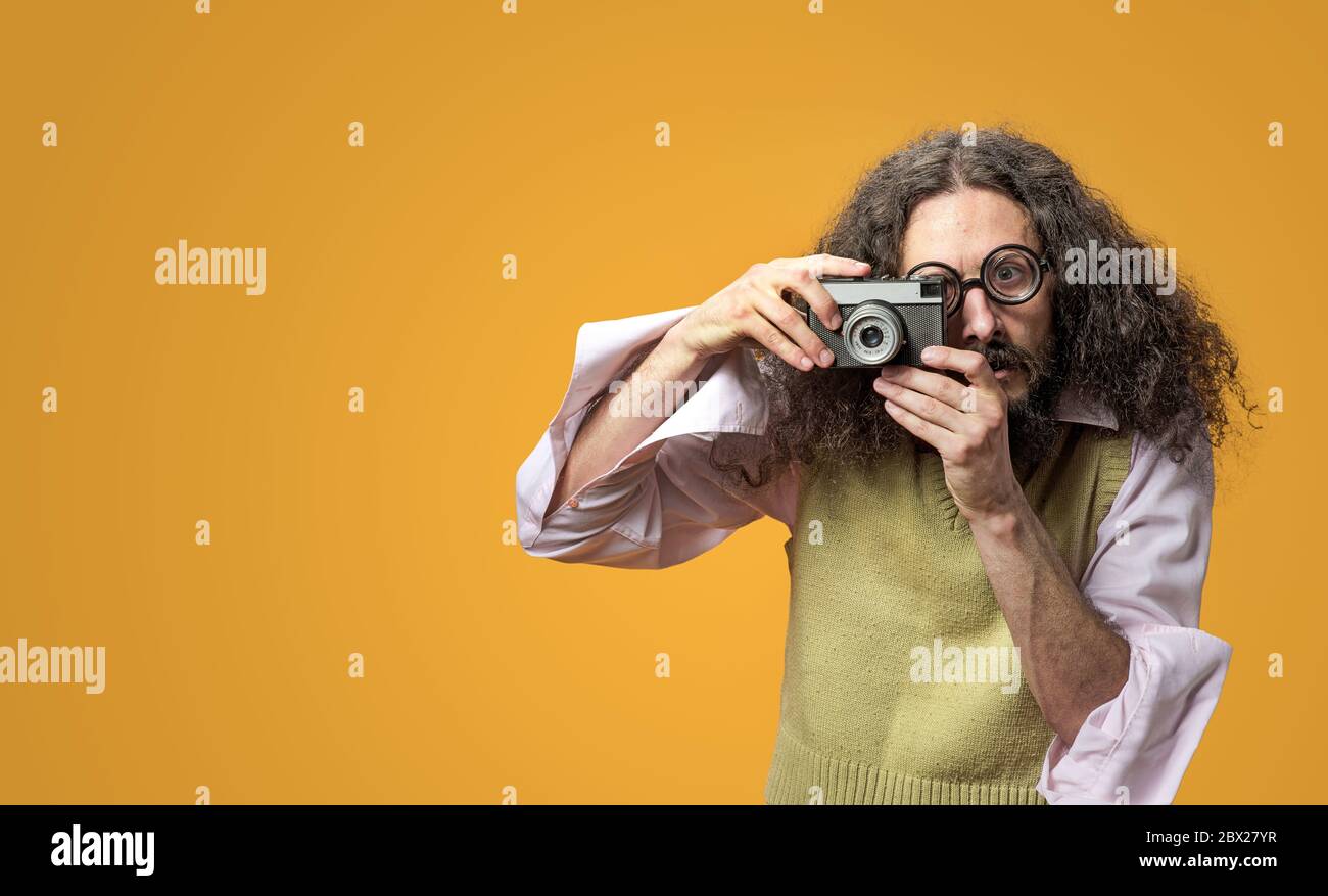 Funny geek taking a picture with a digital camera Stock Photo - Alamy