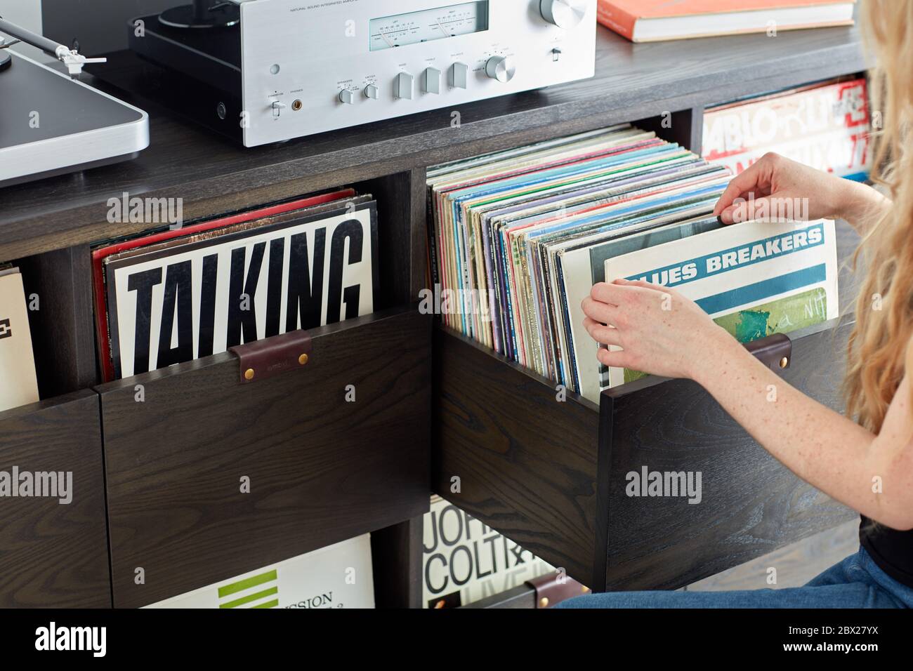 Woman's hands sorting vinyl records in custom storage cabinet Stock ...