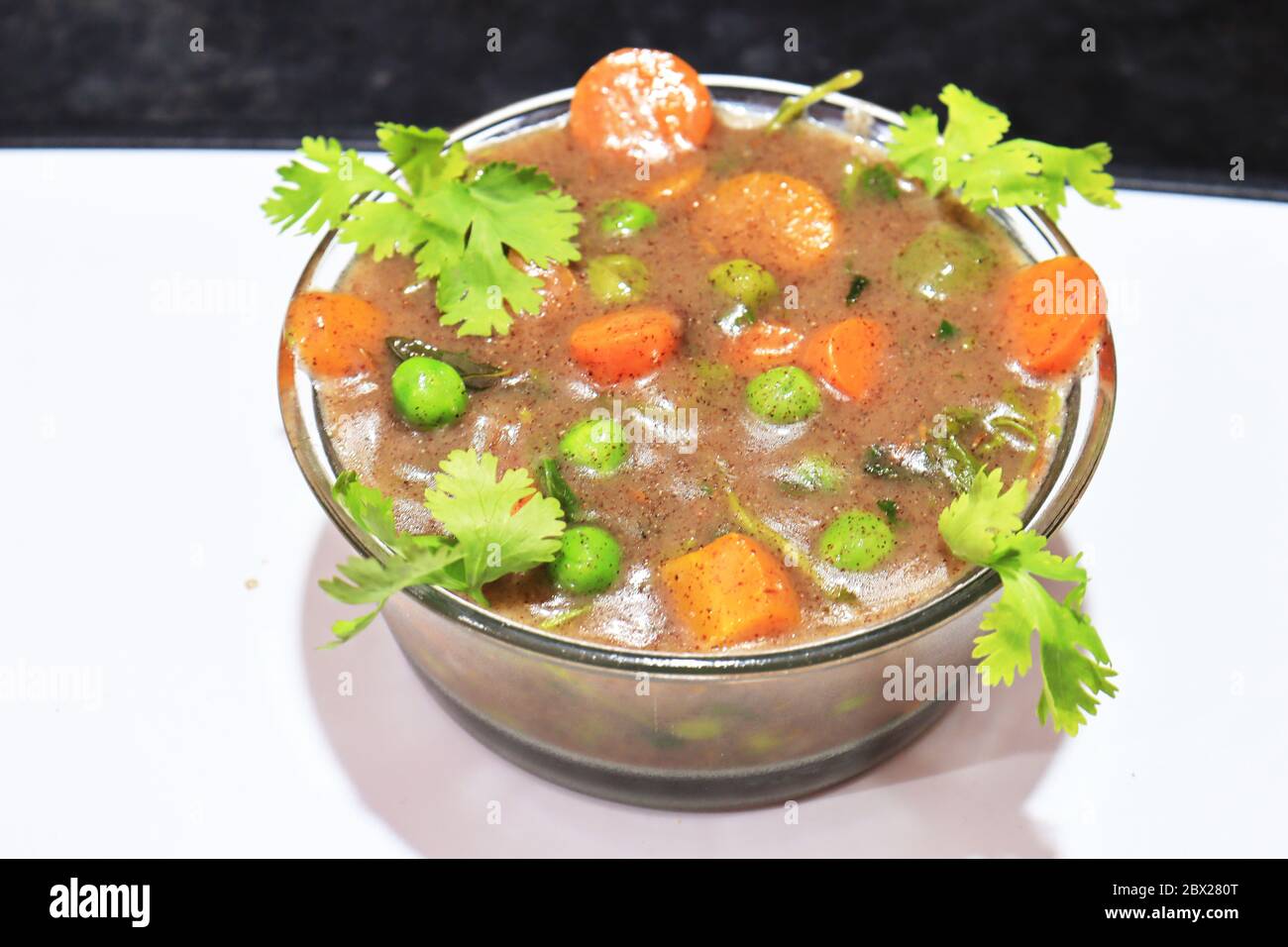 organic finger millet flour soup in a bowl garnished with carrots and ...