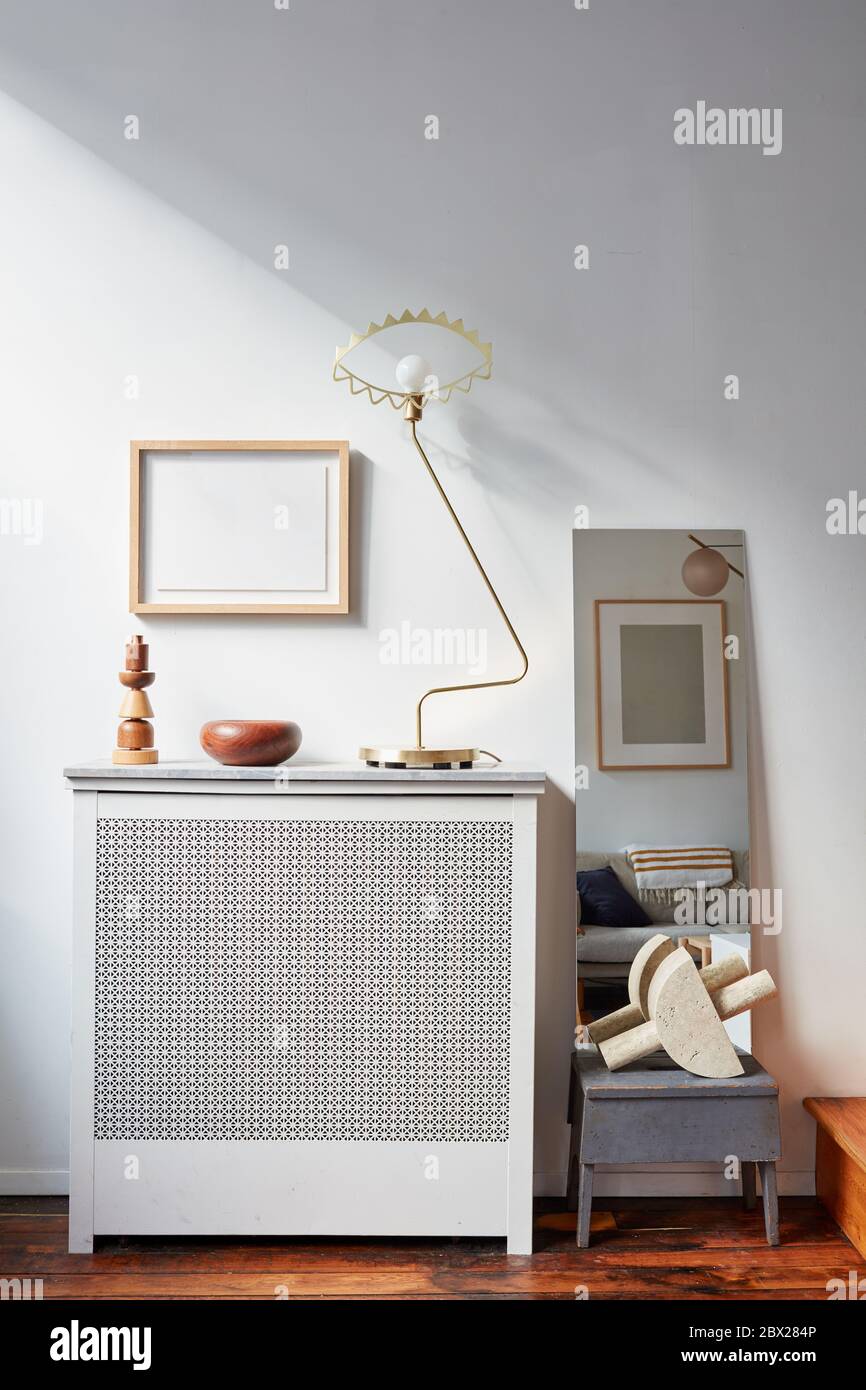 Radiator with lamp wood objects, picture frames Stock Photo - Alamy