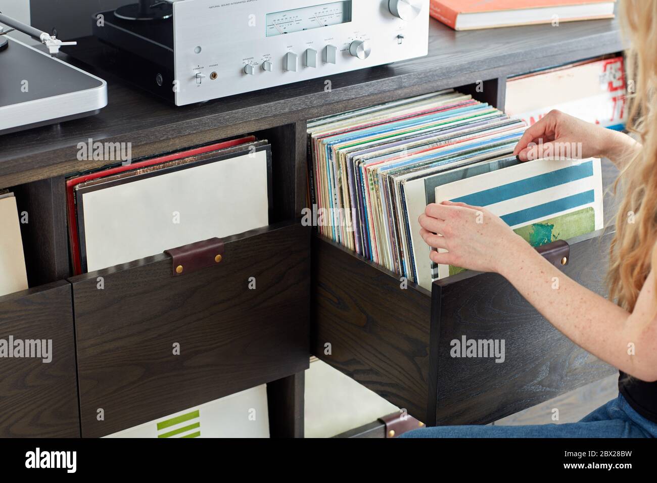 Woman's hand sorting through record collection Stock Photo - Alamy