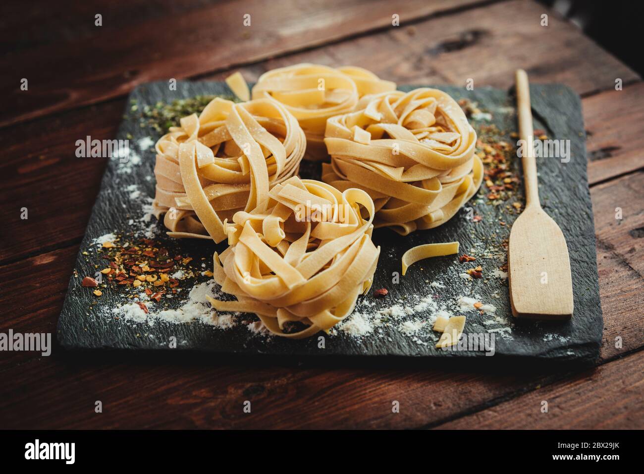 Delicious fresh Italian pasta, fettuccini with spices Stock Photo - Alamy