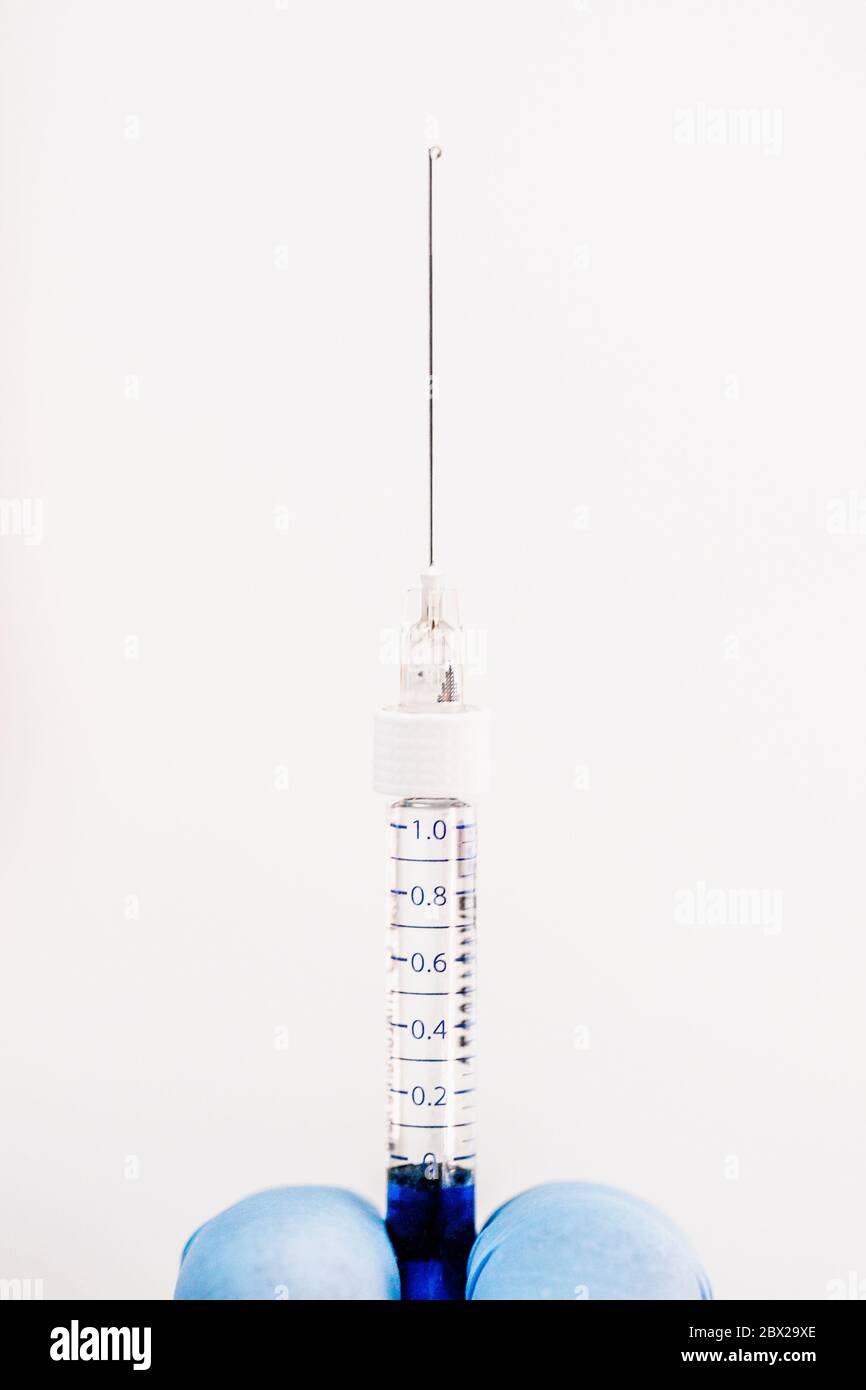Vertical image format - A small medical syringe with a needle in the ...