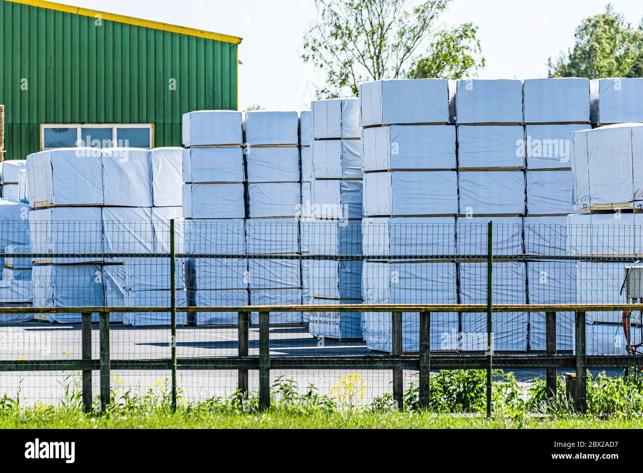 finished goods warehouse in the open air. Pallets boxes are covered ...