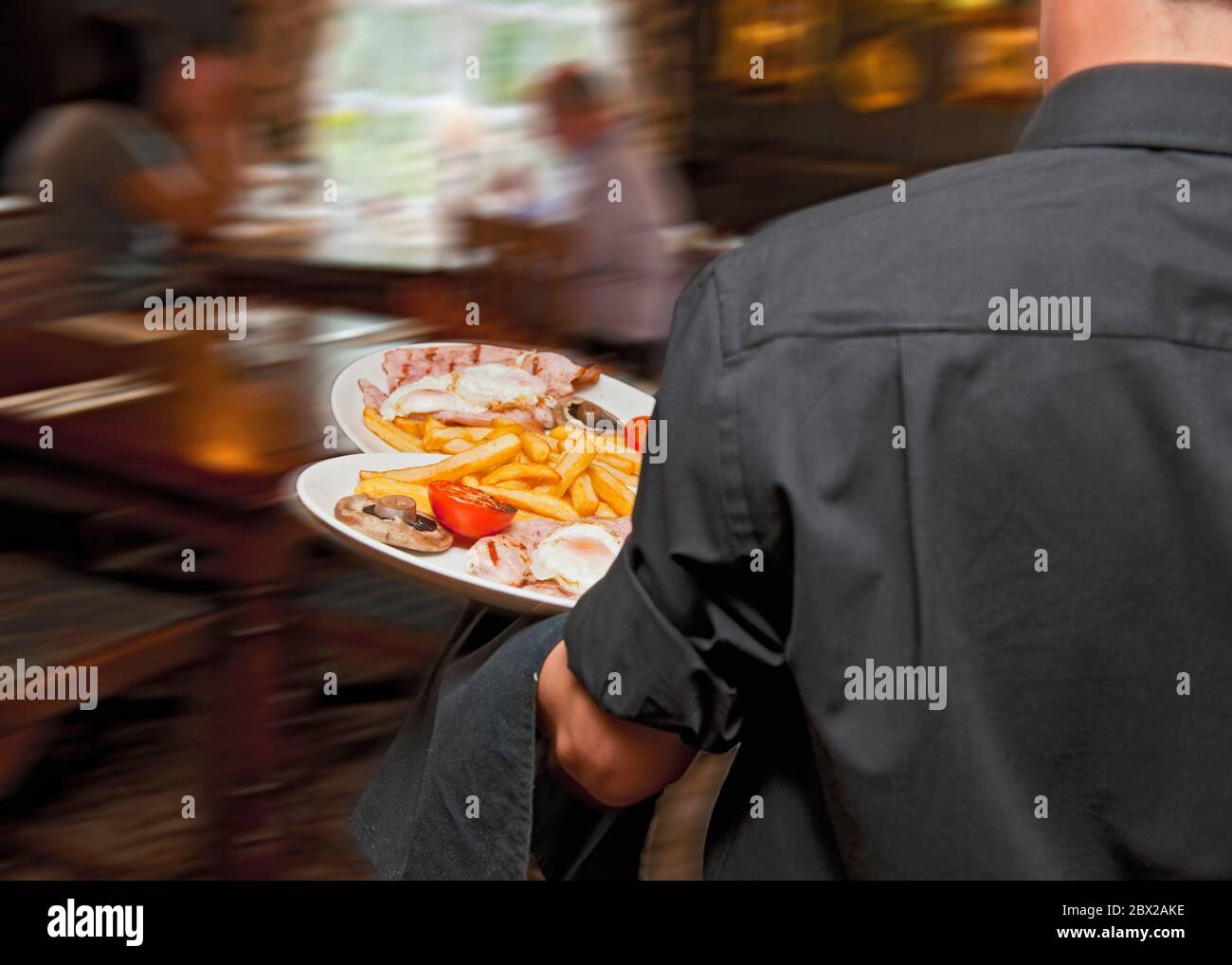 waiter serving food at British pub Stock Photo - Alamy