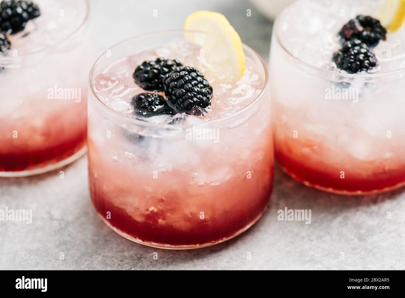 High angle view of Bramble cocktails in a row Stock Photo - Alamy
