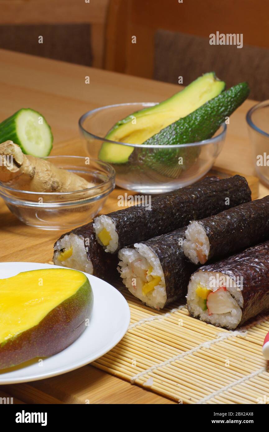 Sushi rolls before cutting. The end of sushi work Stock Photo - Alamy