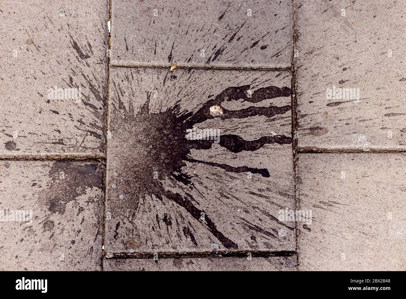 a black splatter on the pavement Stock Photo - Alamy