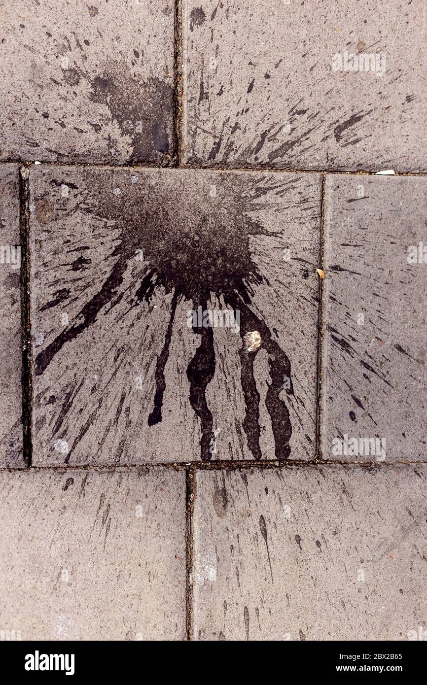 a black splatter on the pavement Stock Photo - Alamy