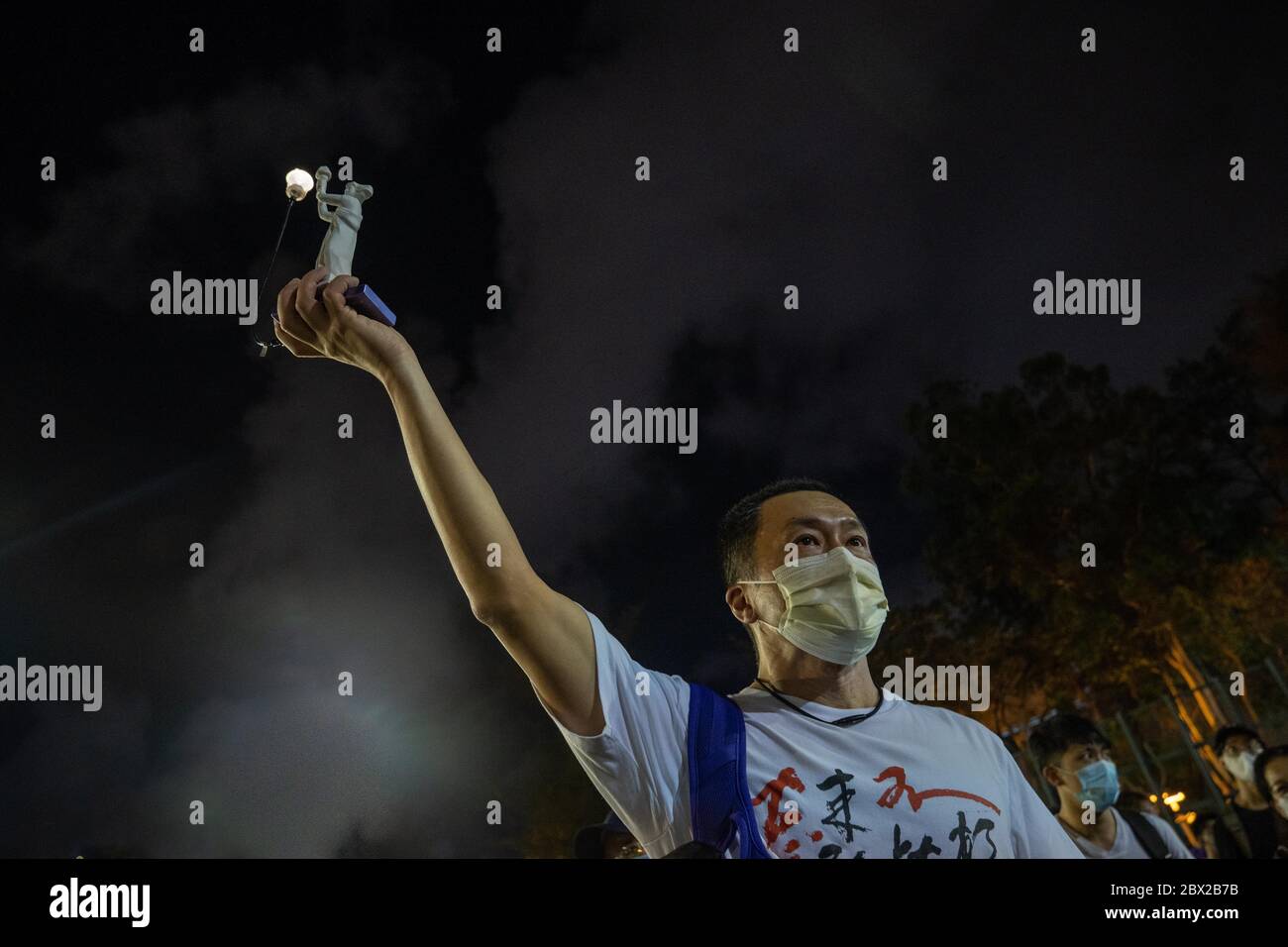 A protester was seen holding a figure of "Goddess of Democracy", one of ...