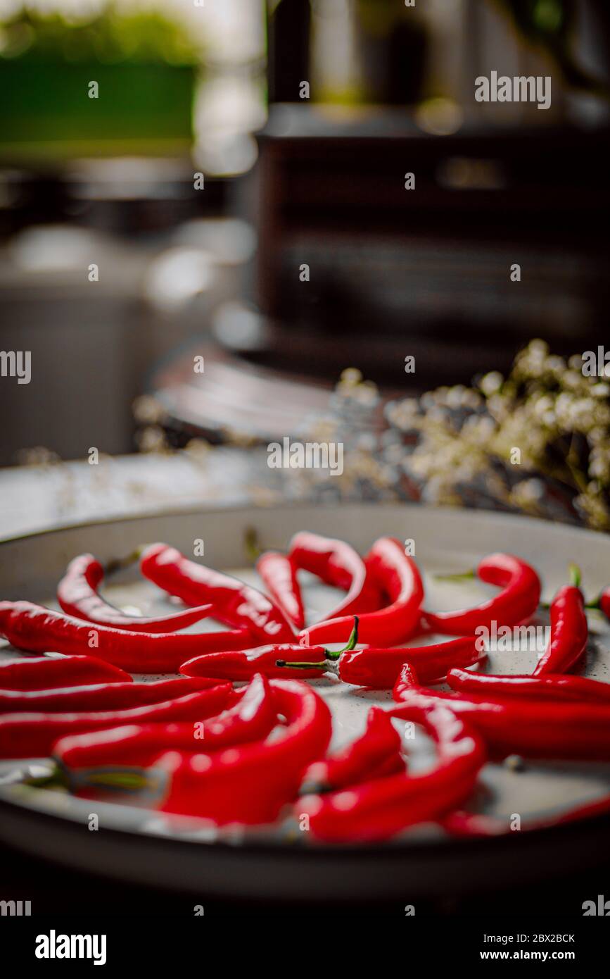 Red hot chilli peppers in a white tray on wooden background. Spicy ...