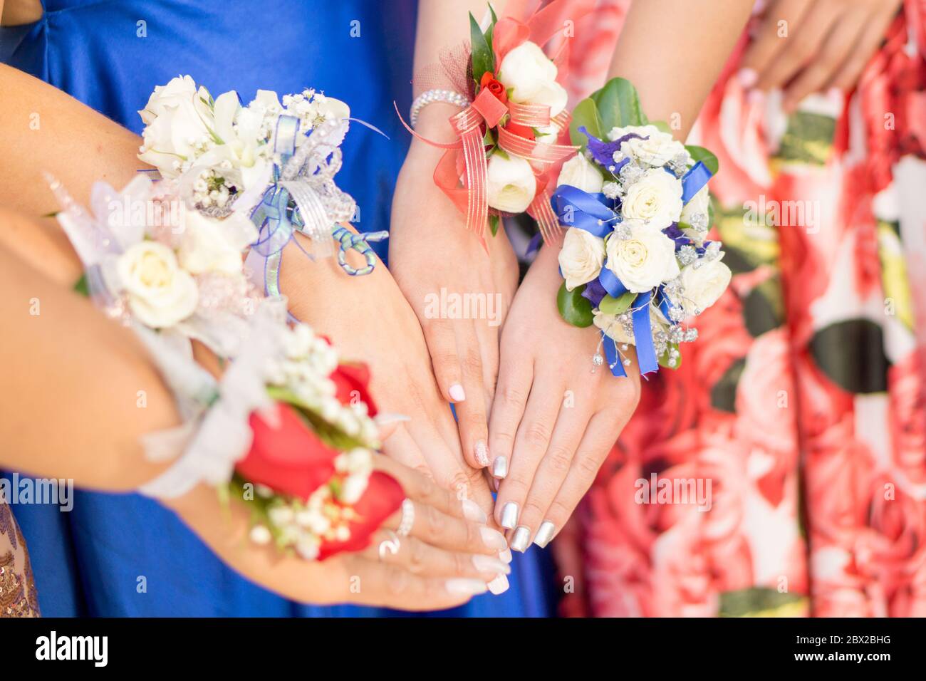 Prom wrist bouquet hands down Stock Photo - Alamy