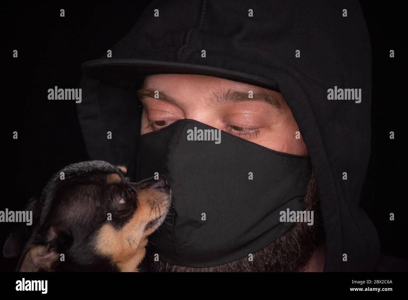 Man in a black mask, Masked guy on self-isolation with a puppy, Boy ...