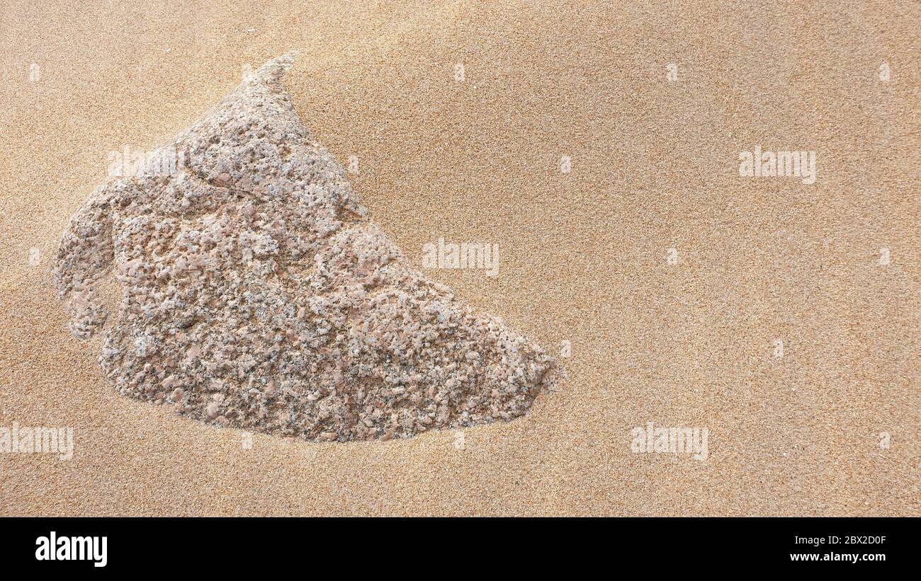Rocks in sand Stock Photo - Alamy