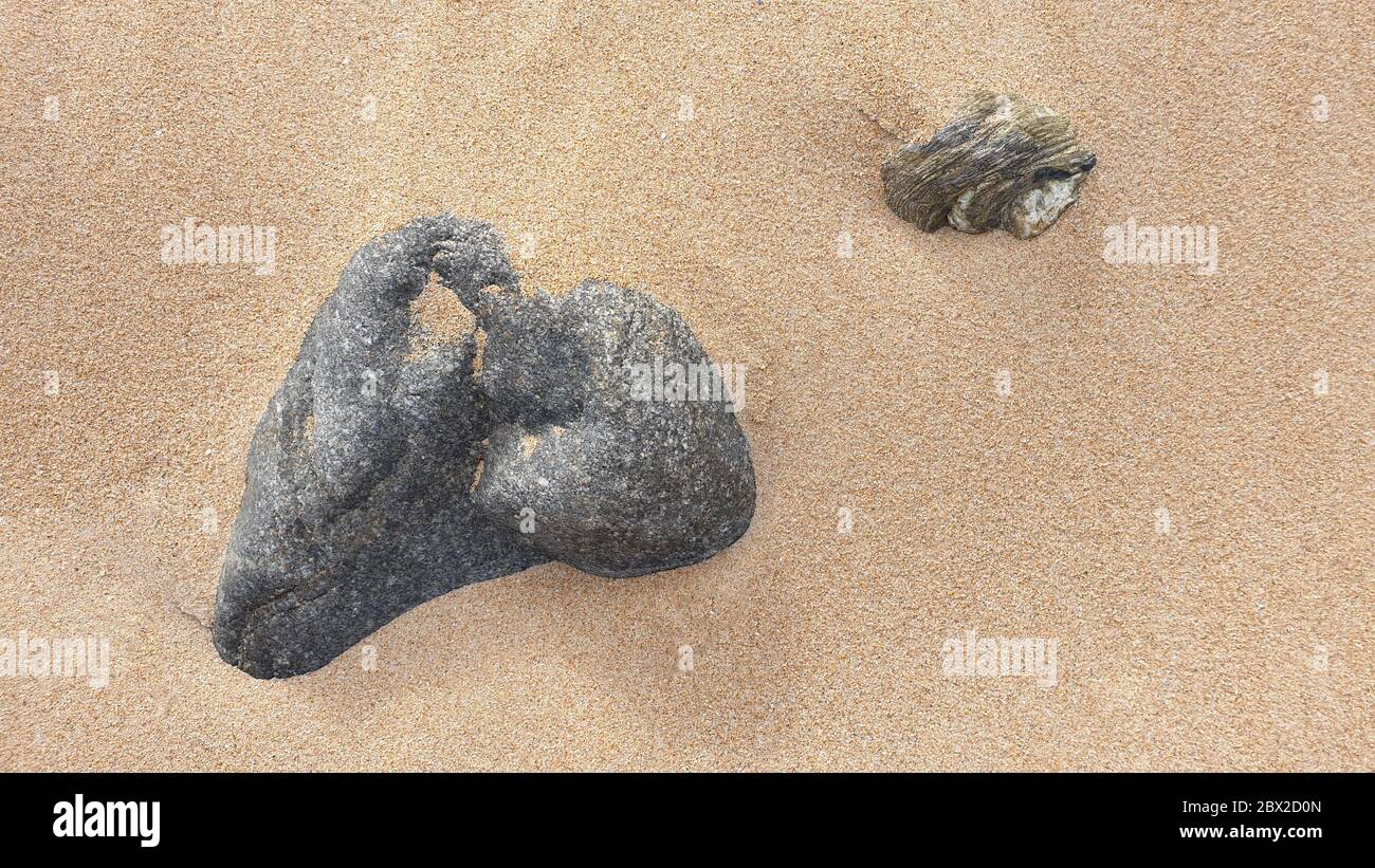 Rocks in sand Stock Photo - Alamy