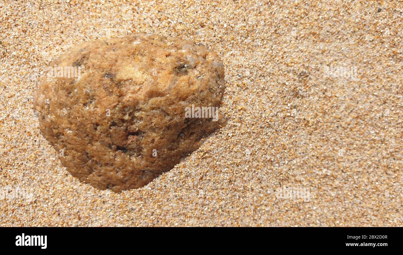 Rocks in sand Stock Photo - Alamy