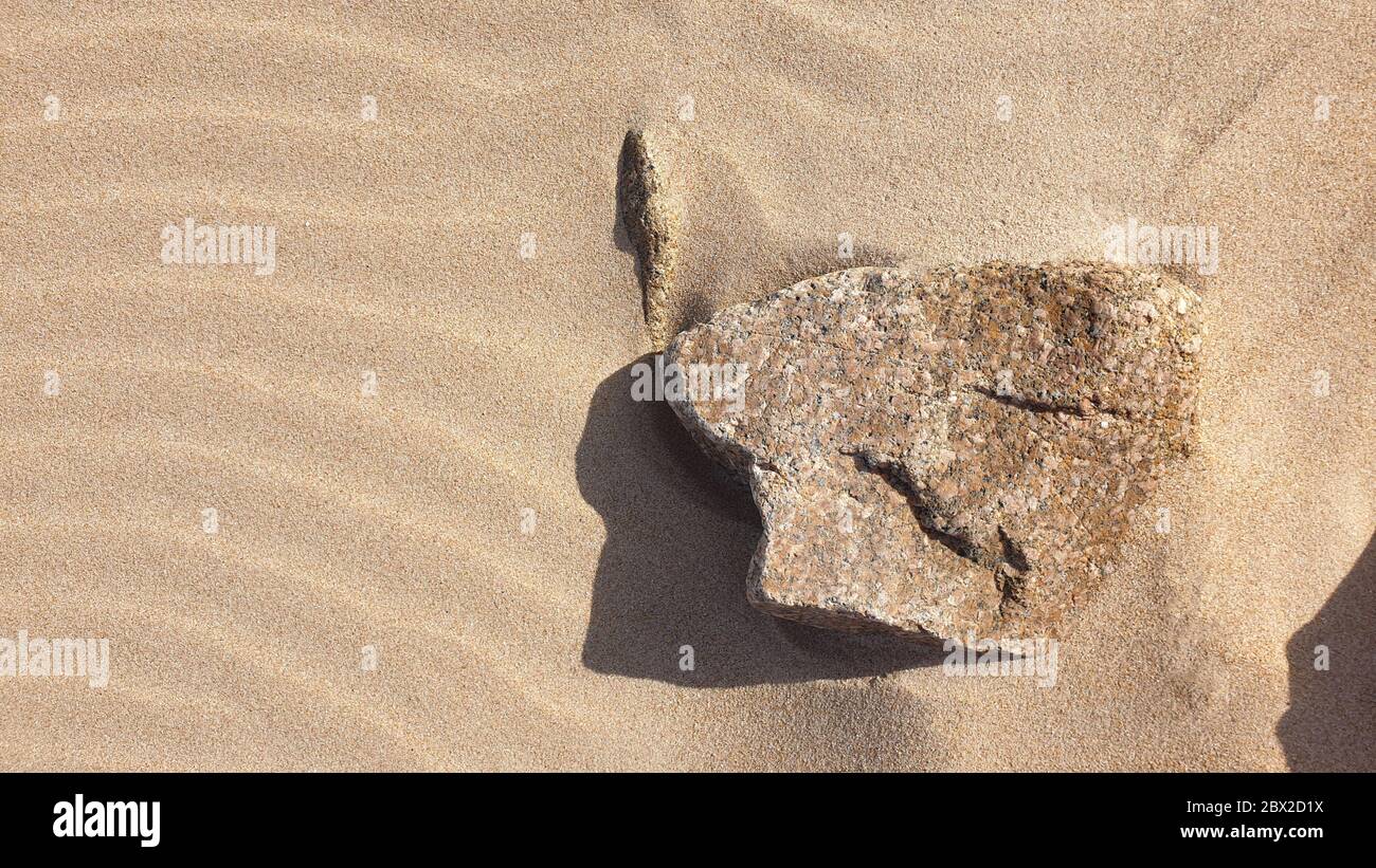 Rocks in sand Stock Photo - Alamy