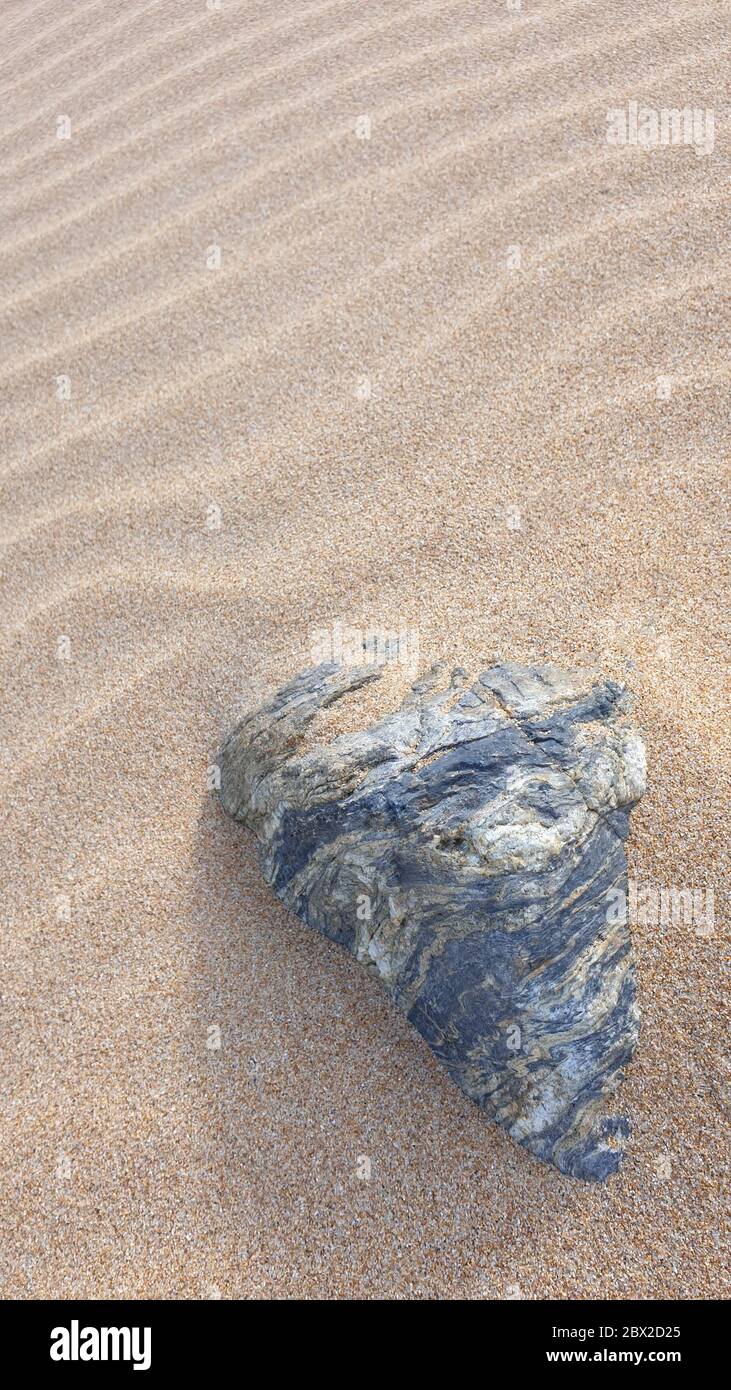 Rocks in sand Stock Photo - Alamy