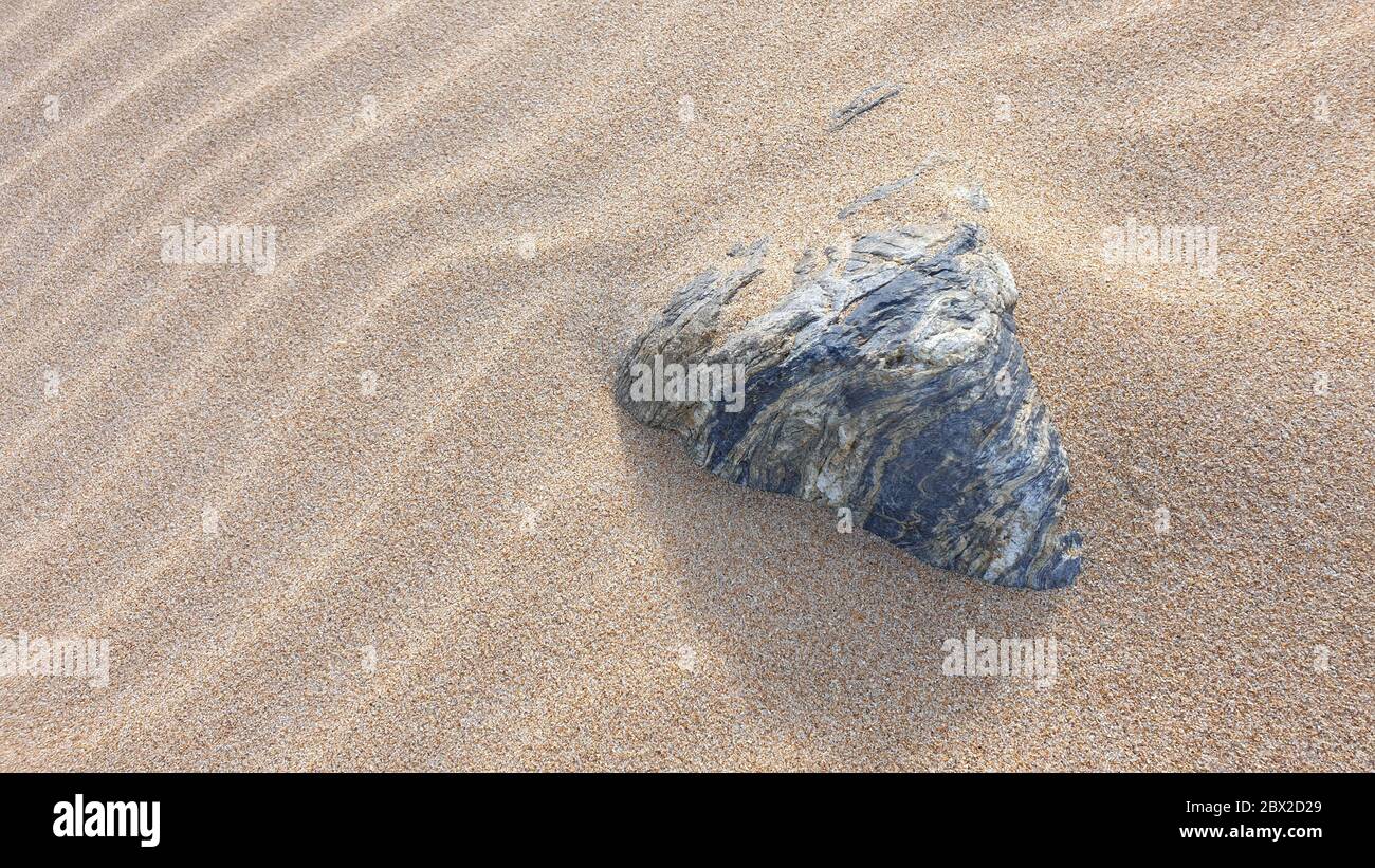 Rocks in sand Stock Photo - Alamy