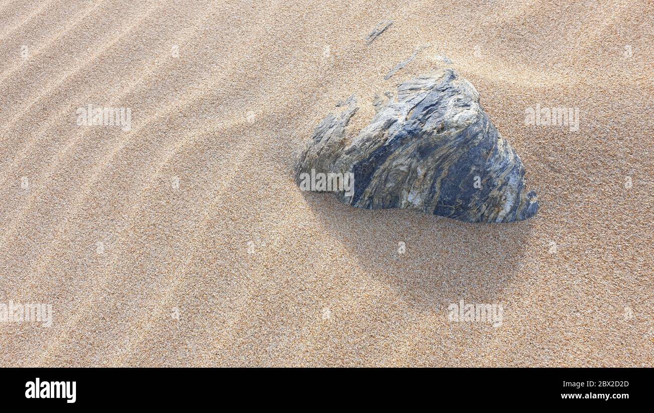 Rocks in sand Stock Photo - Alamy