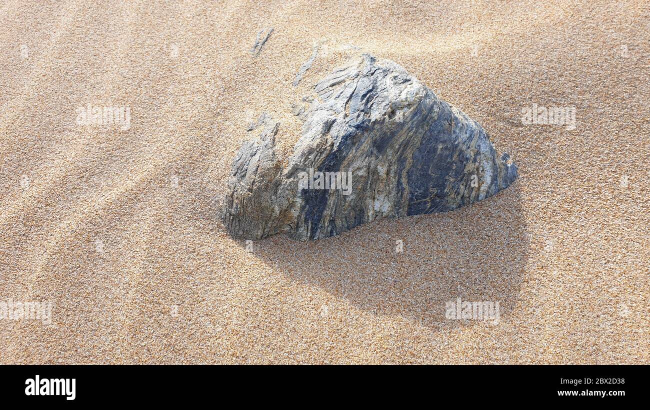 Rocks in sand Stock Photo - Alamy