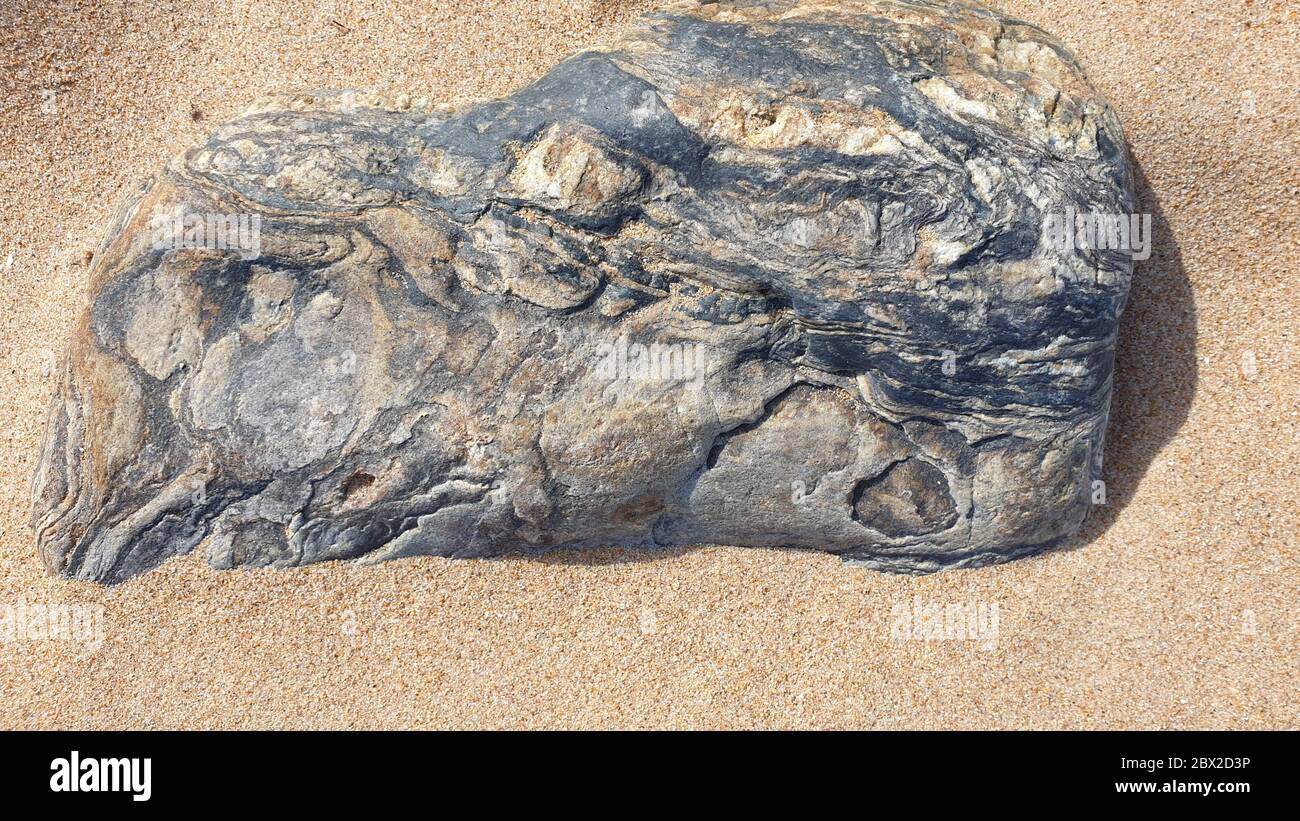 Rocks in sand Stock Photo - Alamy