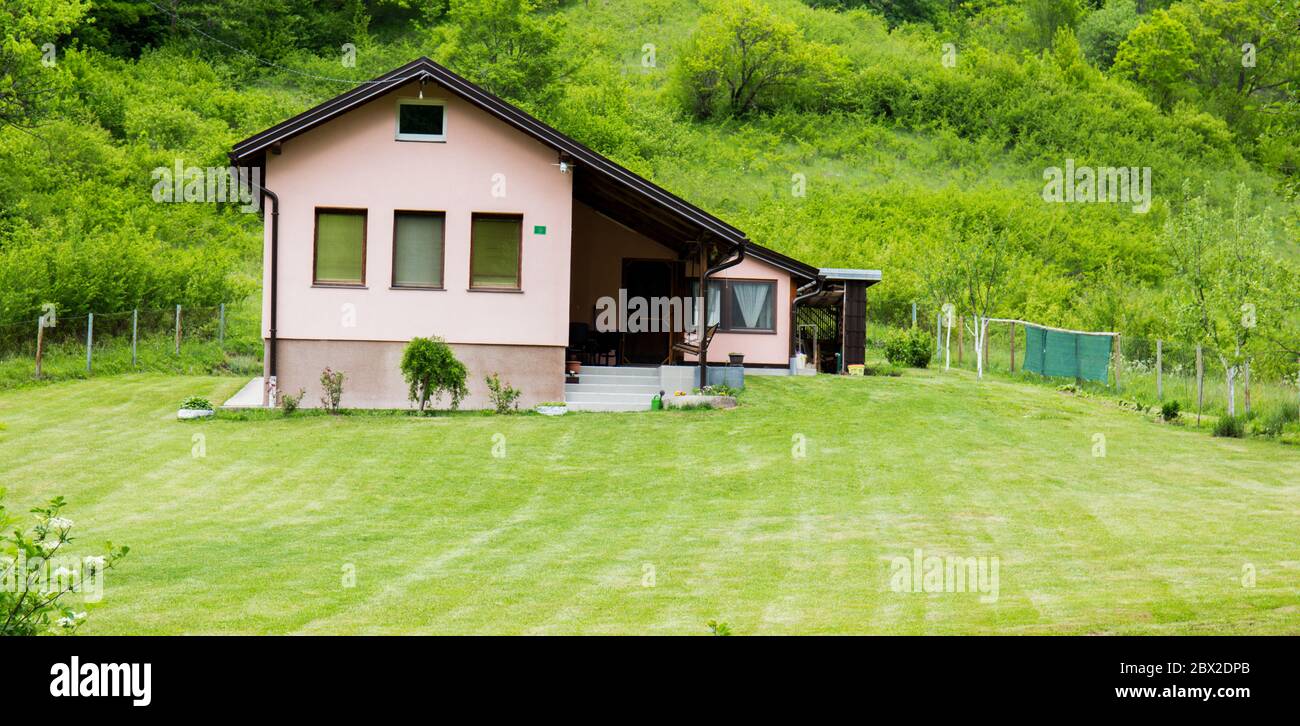 Beautiful little house on the meadow. Cottage in untouched nature Stock ...