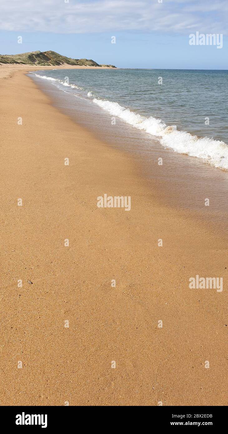 Waves arriving on beach Stock Photo - Alamy