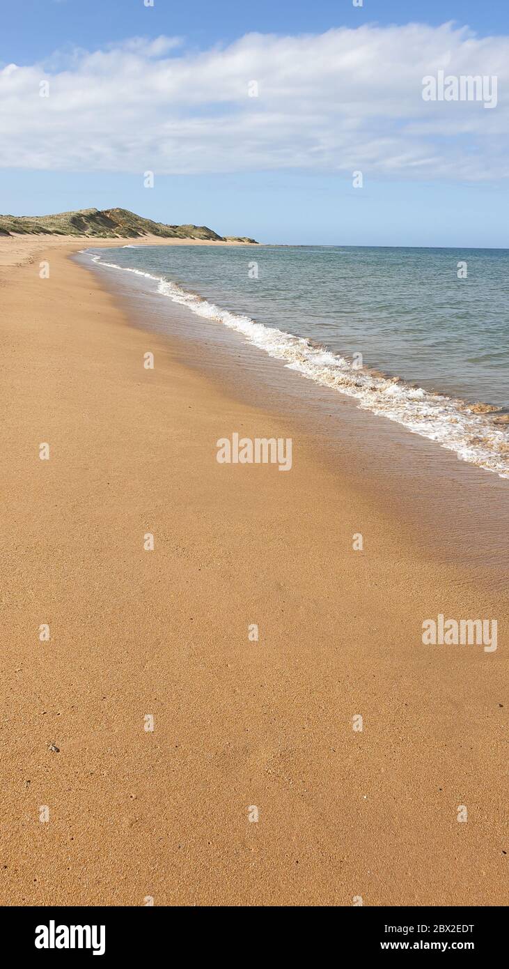 Waves arriving on beach Stock Photo - Alamy