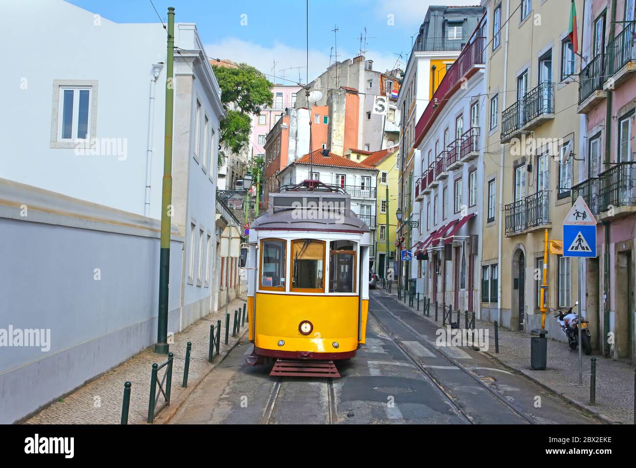 Historic yellow tram against old town streets, part of the tramway ...